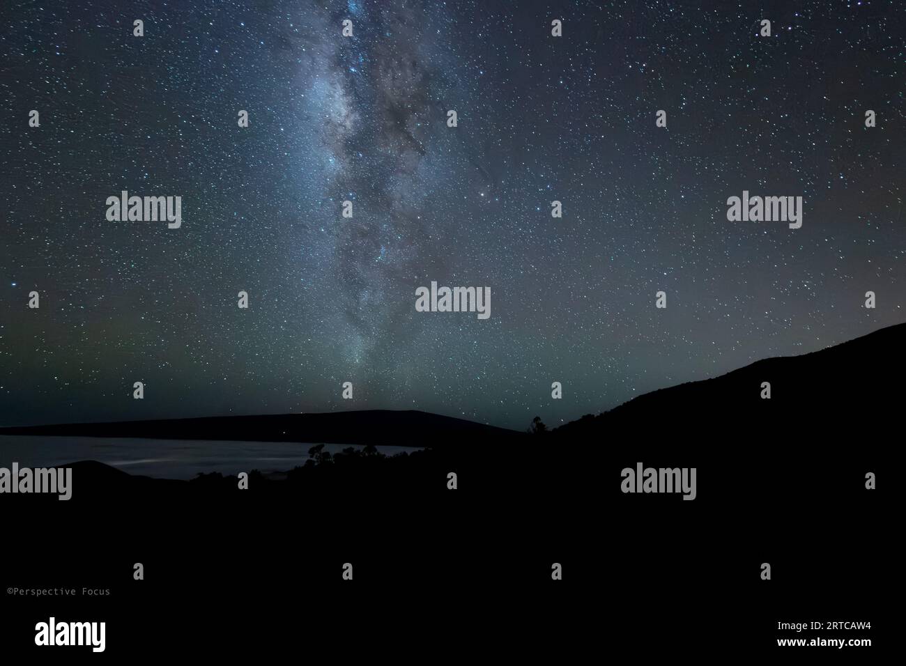 A tranquil landscape of a glistening lake and majestic mountains ...