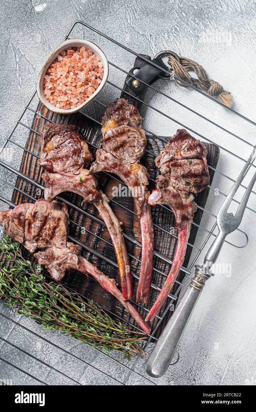 Barbecue grilled lamb meat chop on a grill, mutton rib cutlet. White ...