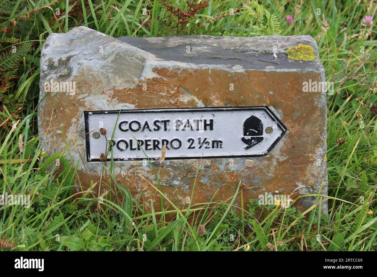 Coastal Path walking sign with acorn in Cornwall showing Polperro 2.5 ...