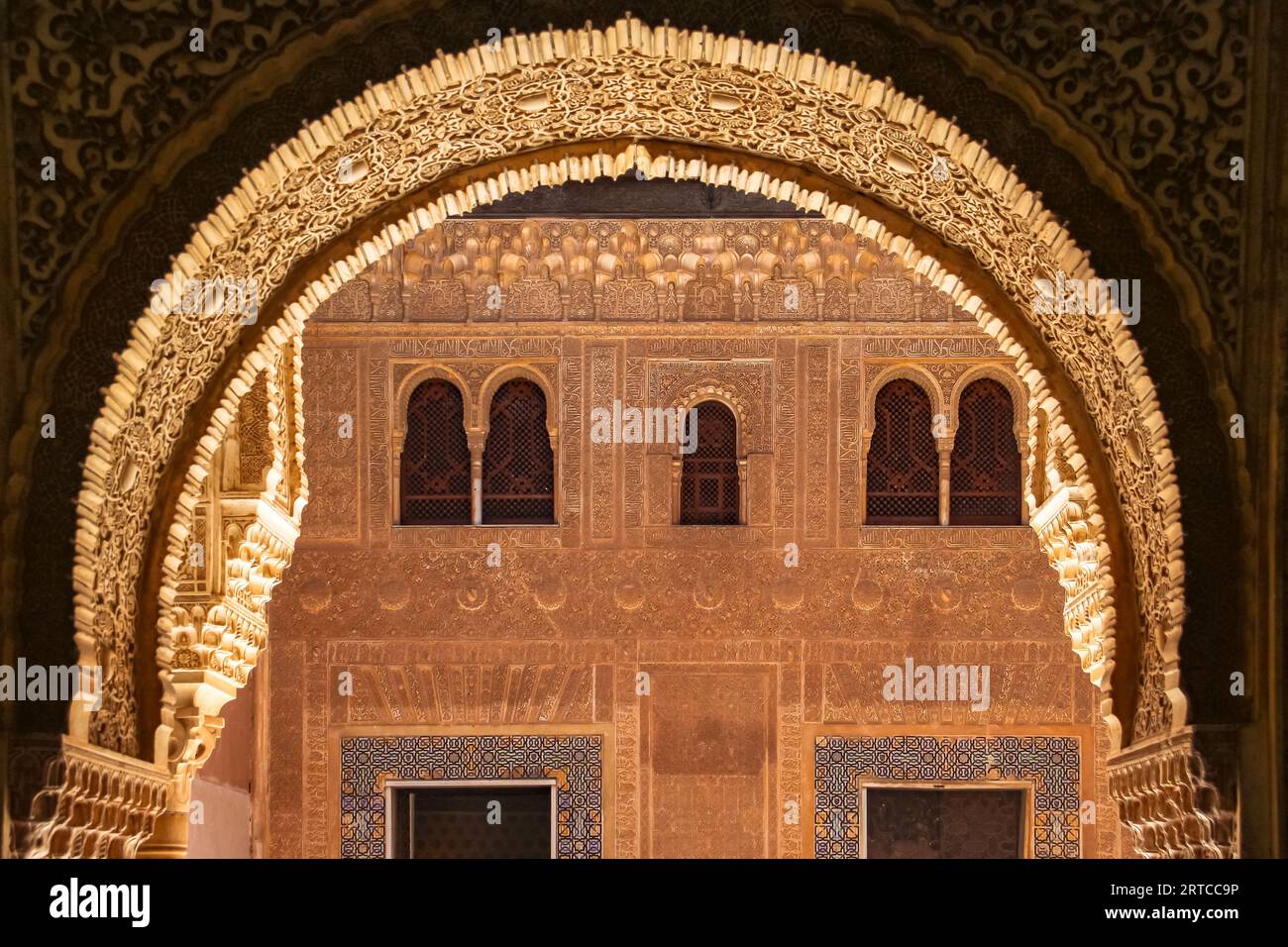 A backlit ornate archway of the Nasrid Palaces, the important Alhambra ...