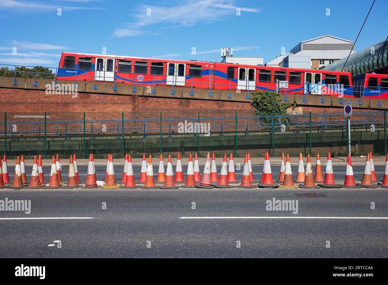 Traffic cones on A1261 Aspen Way, DLR train in the background; London ...
