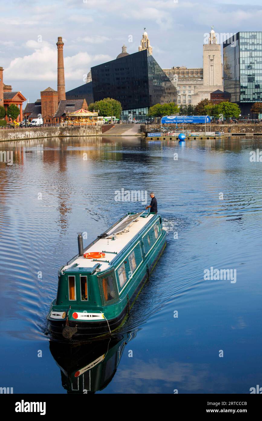 A barge at the Albert Dock in Liverpool with the Liver building in the ...