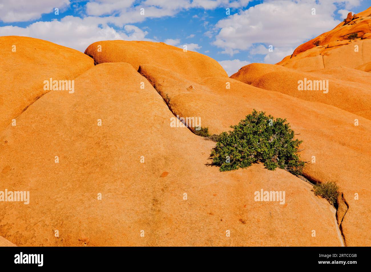 Distinctive orange granite boulders in the rocky plateau region of the ...