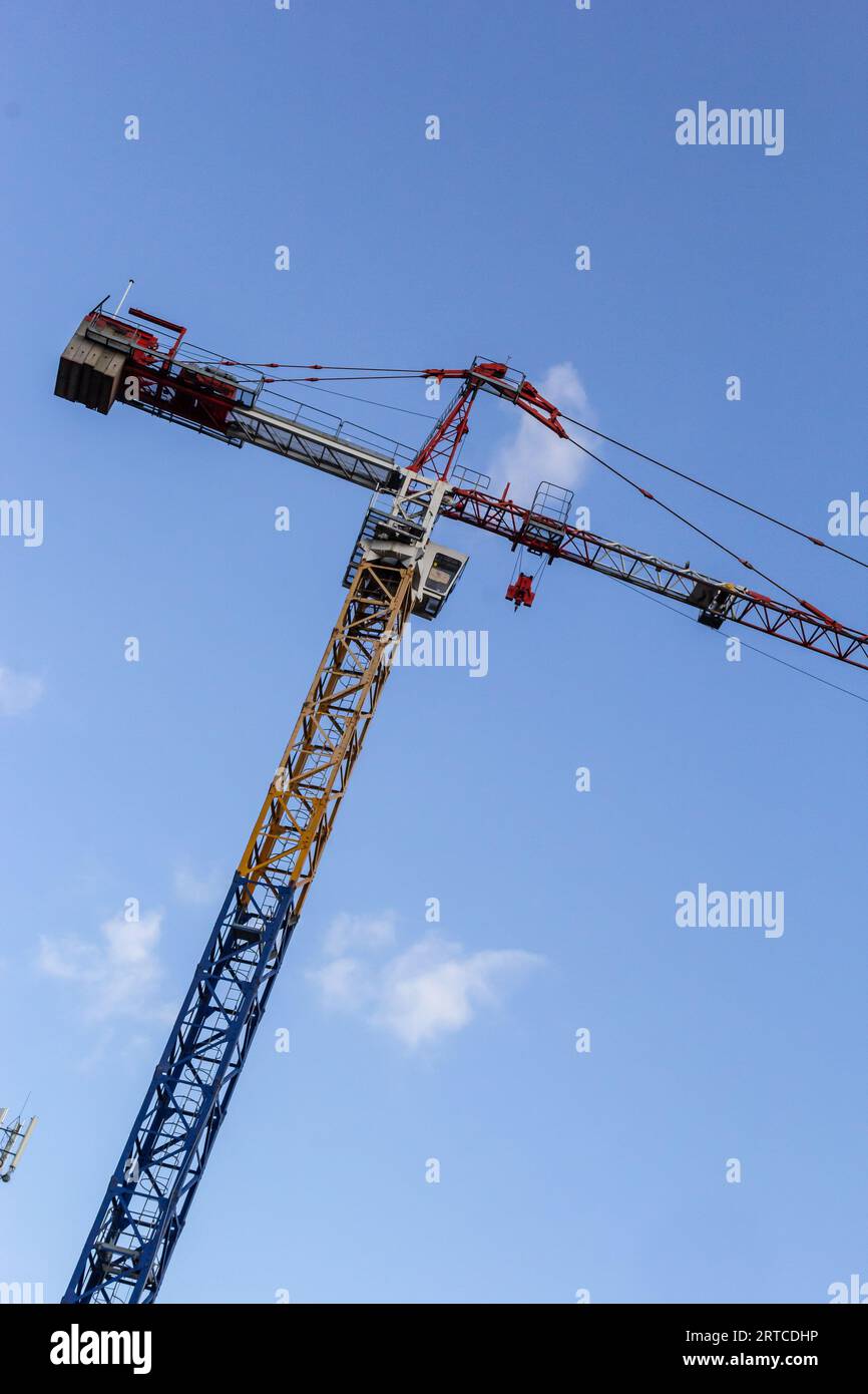 Tower cranes building a house. Concrete building under construction ...