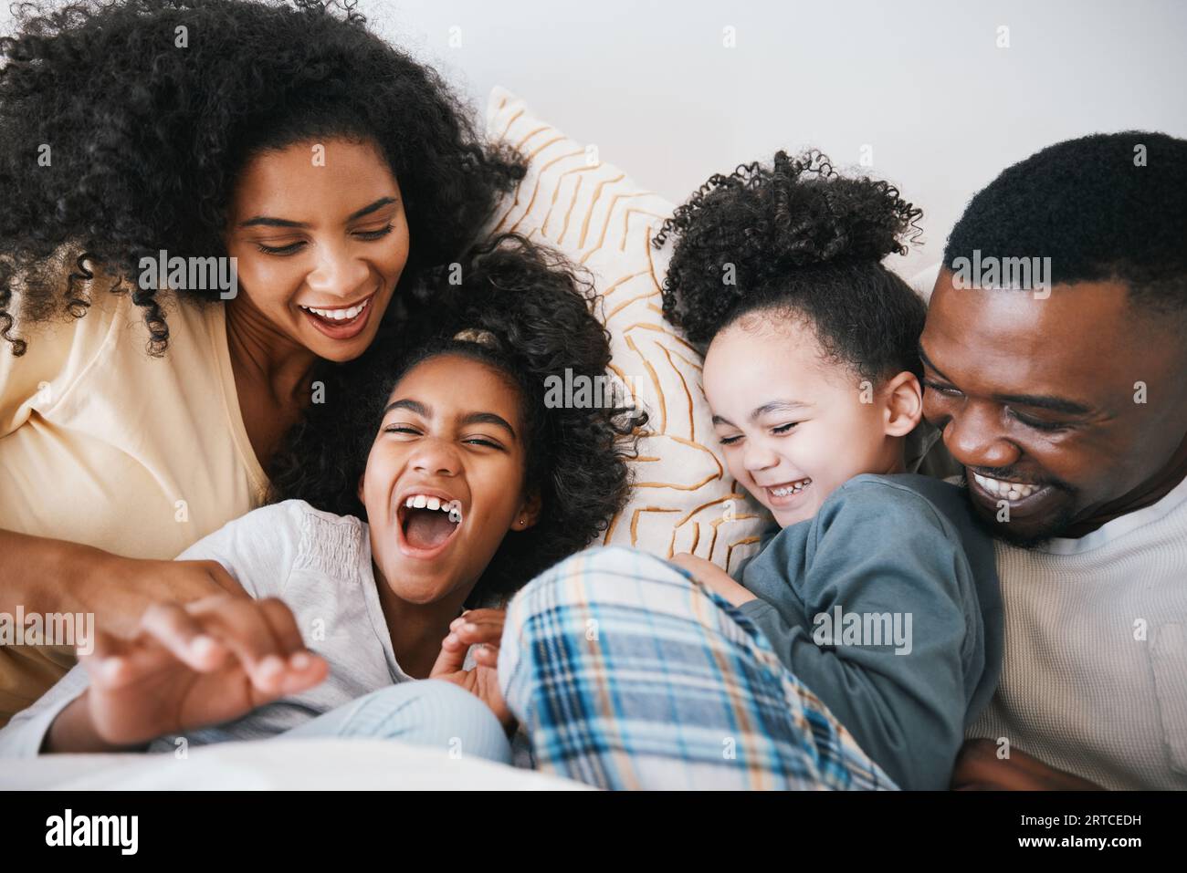 Mother tickling daughter in bedroom hi-res stock photography and images - Alamy