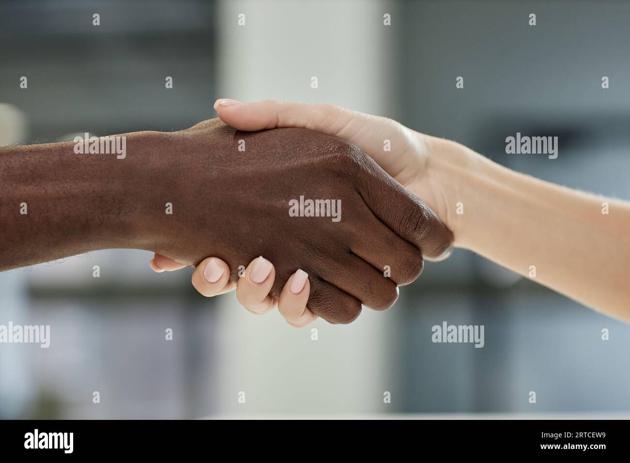 Close-up of hands of young intercultural patient and clinician giving ...