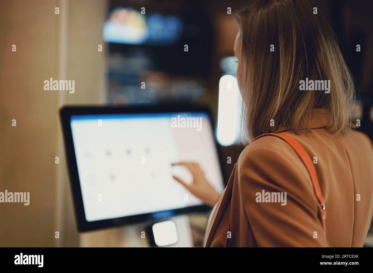 Woman pays at self-checkouts in supermarket Stock Photo - Alamy