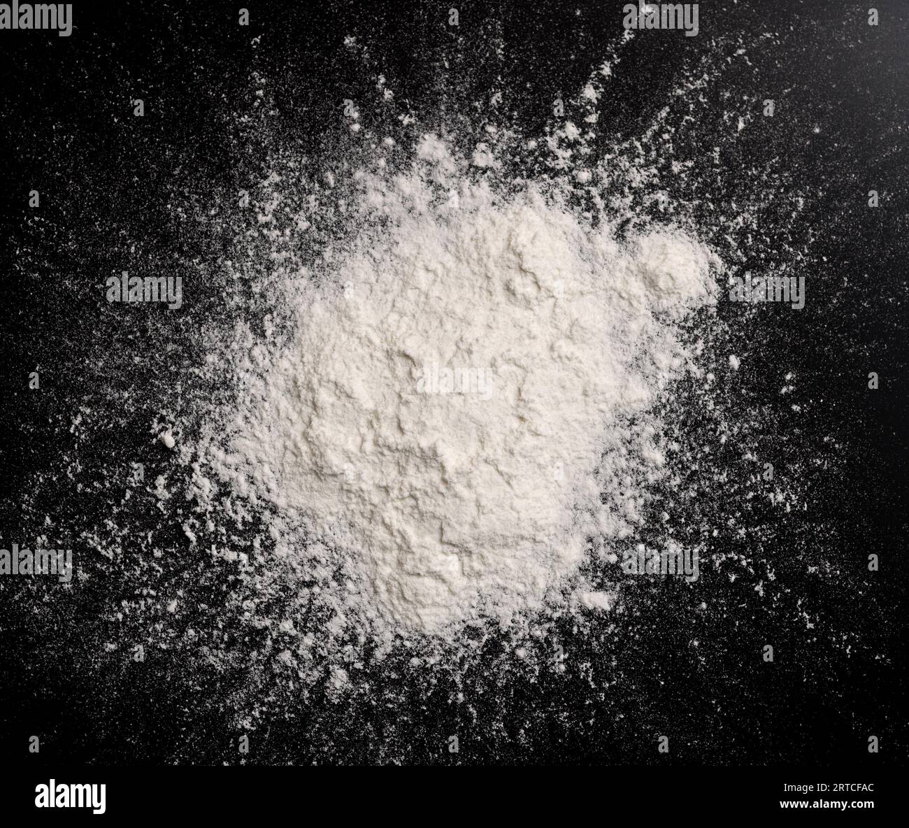 Wheat flour on black background Stock Photo - Alamy
