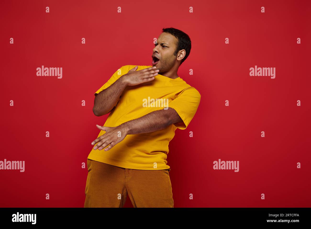emotional indian man in bright casual clothes showing expressive ...