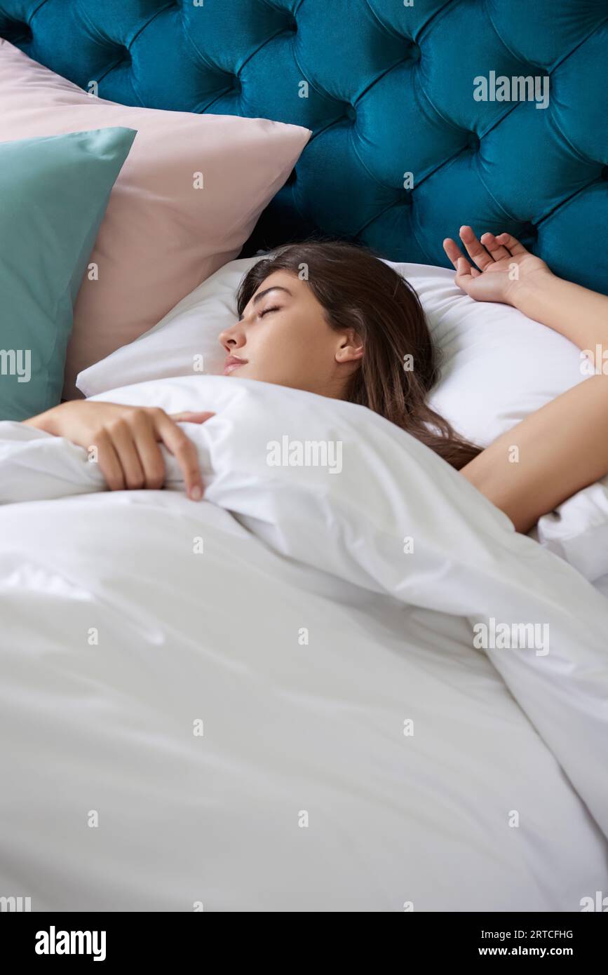 Beautiful young model preparing for bed, sleeping in bed bedroom scene ...