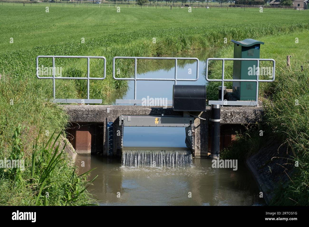 Closeup of a small weir in a stream for water level control in a Dutch ...