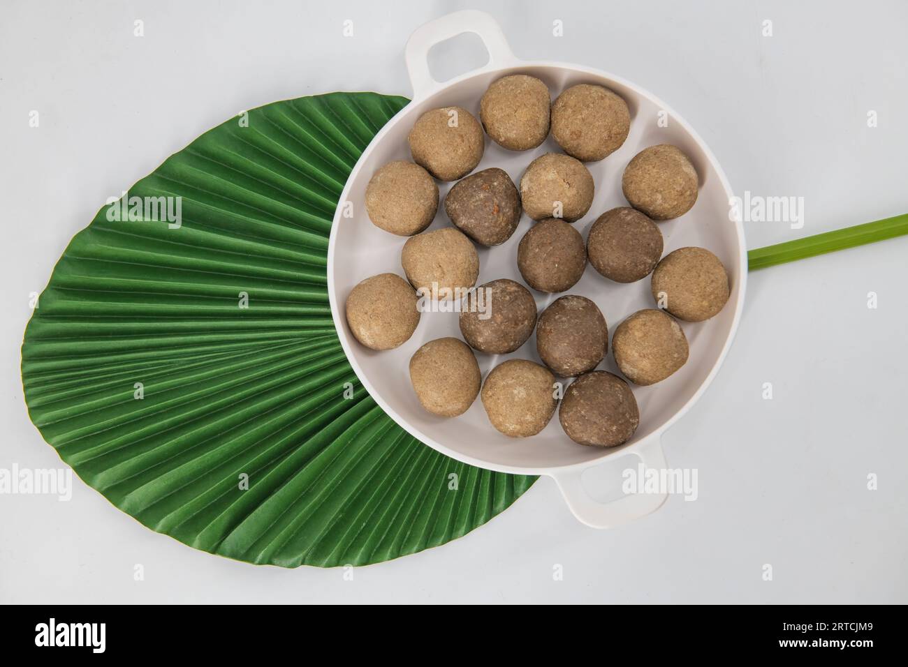 Fresh home made urad dal and millet laddu isolated and decorated ...