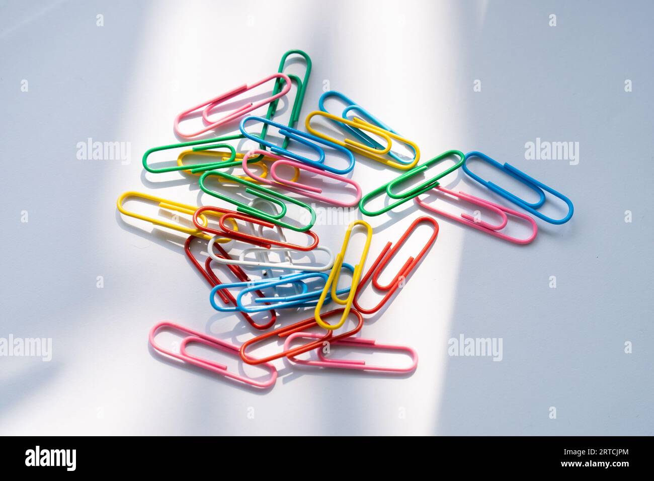 Colored paper clips close-up on a white background Stock Photo - Alamy