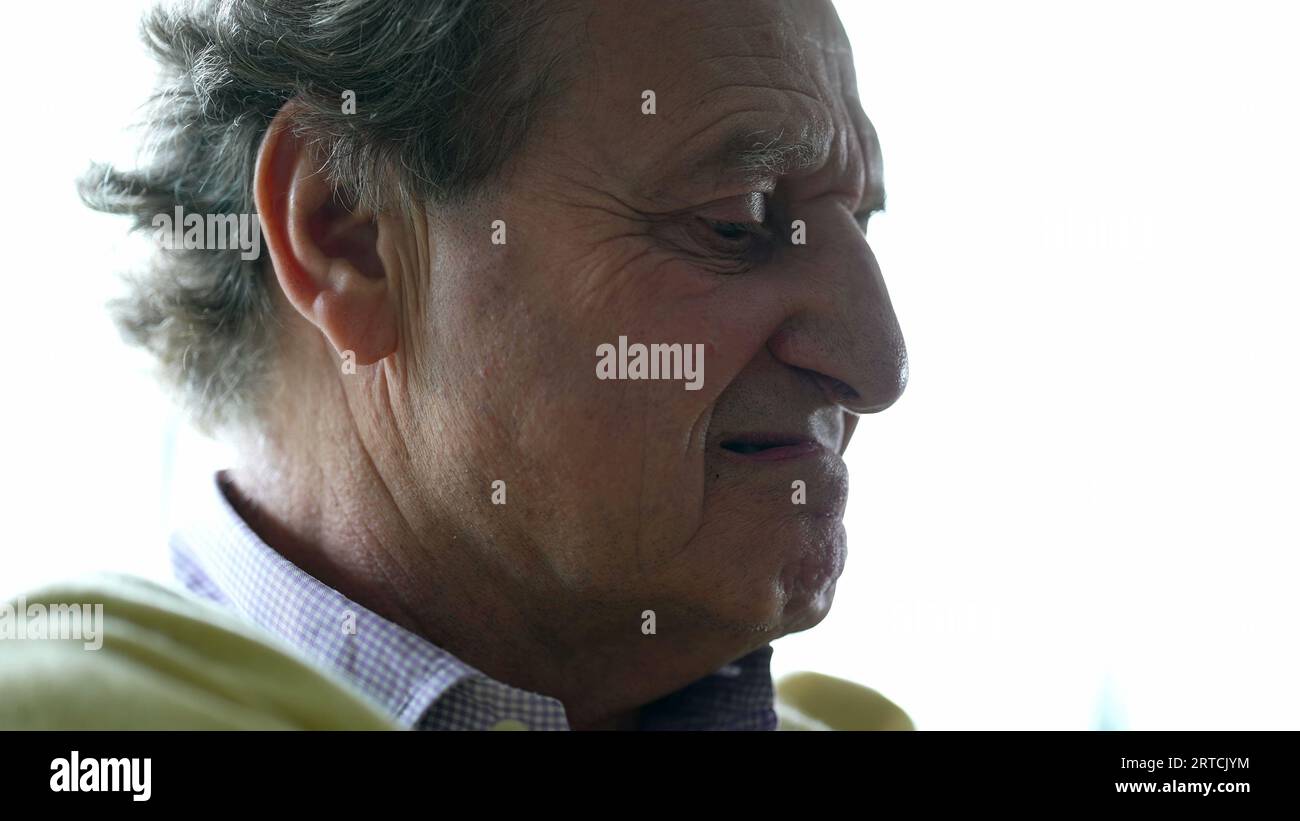 Anxious senior man close-up face biting lips feeling distressed while ...