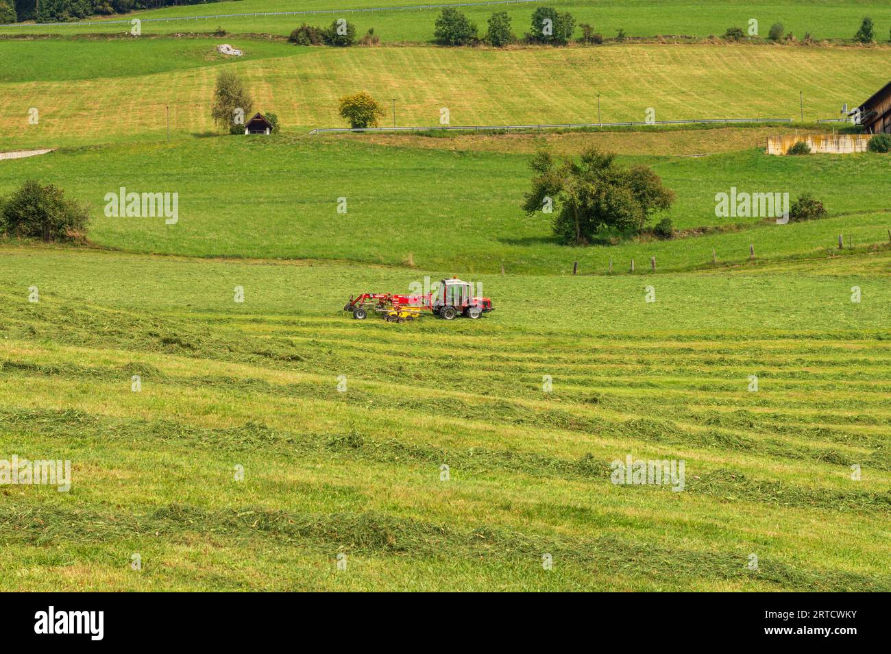 Red tractor working in agriculture in Meransen, South Tyrol, Italy ...