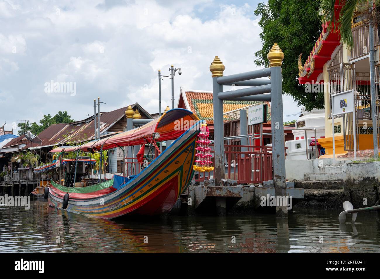 A klong or river channel of Chao Phraya river with longtail wooden ...