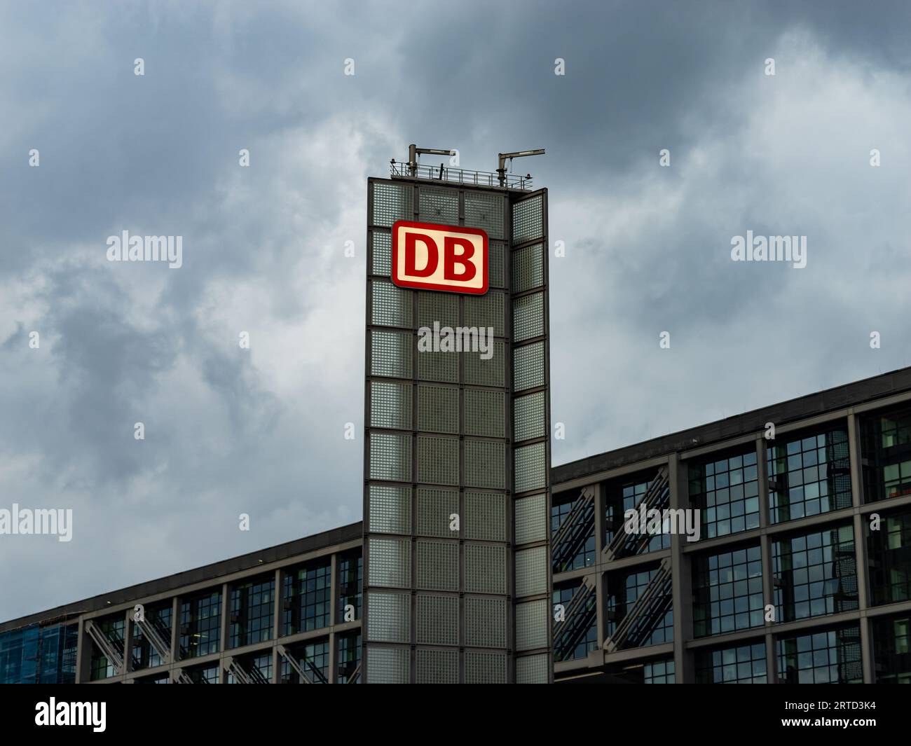 Deutsche Bahn logo sign in front of a dramatic sky. Stormy weather as ...