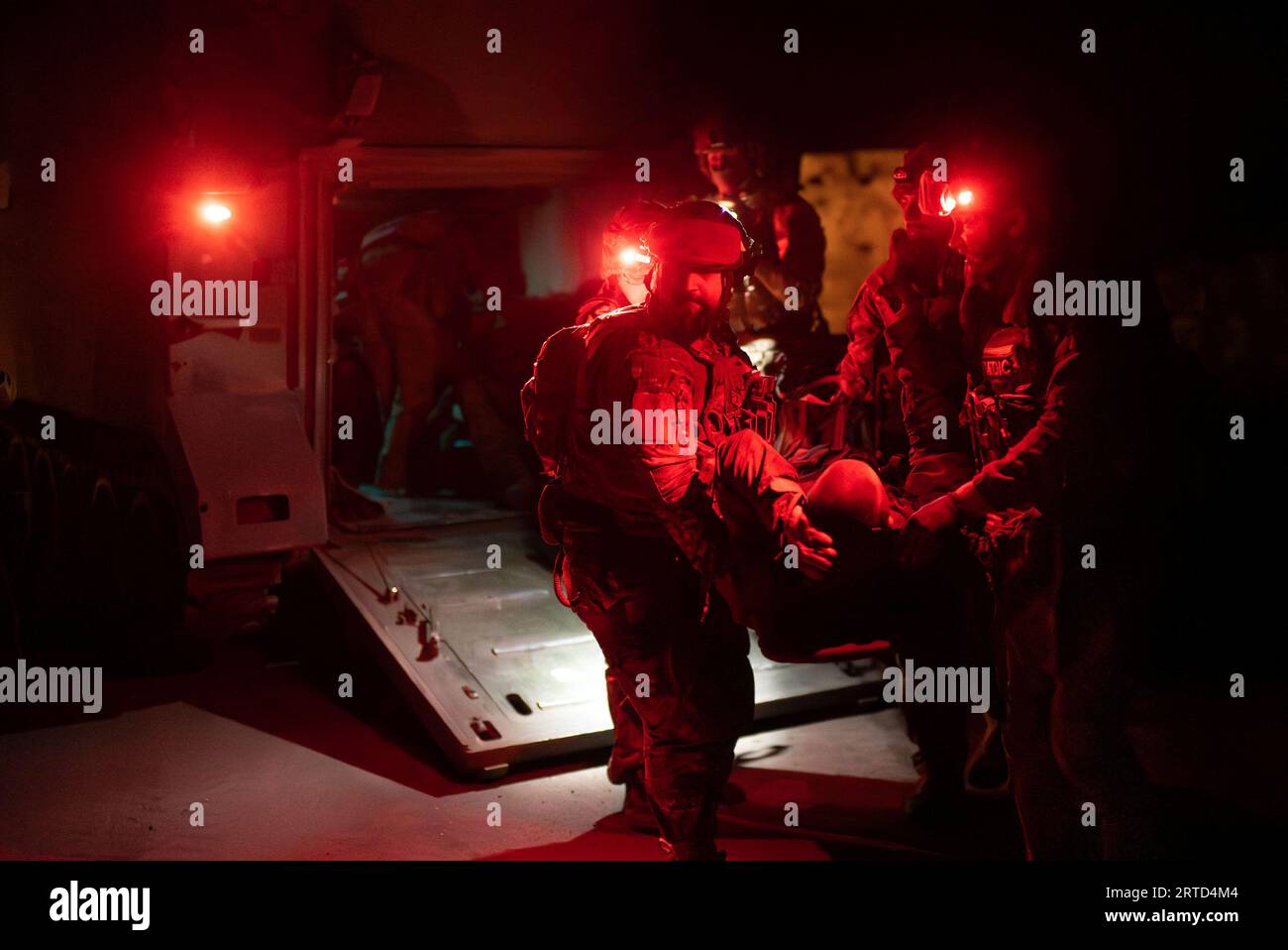 Ukrainian paramedics from 3rd Assault brigade carry on a stretcher ...