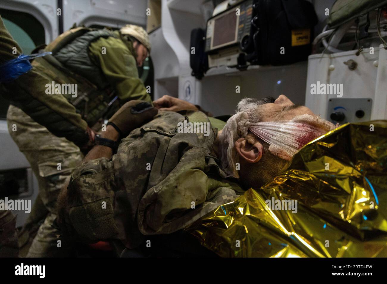 A wounded Ukrainian soldier of 3rd Assault brigade is treated by a ...