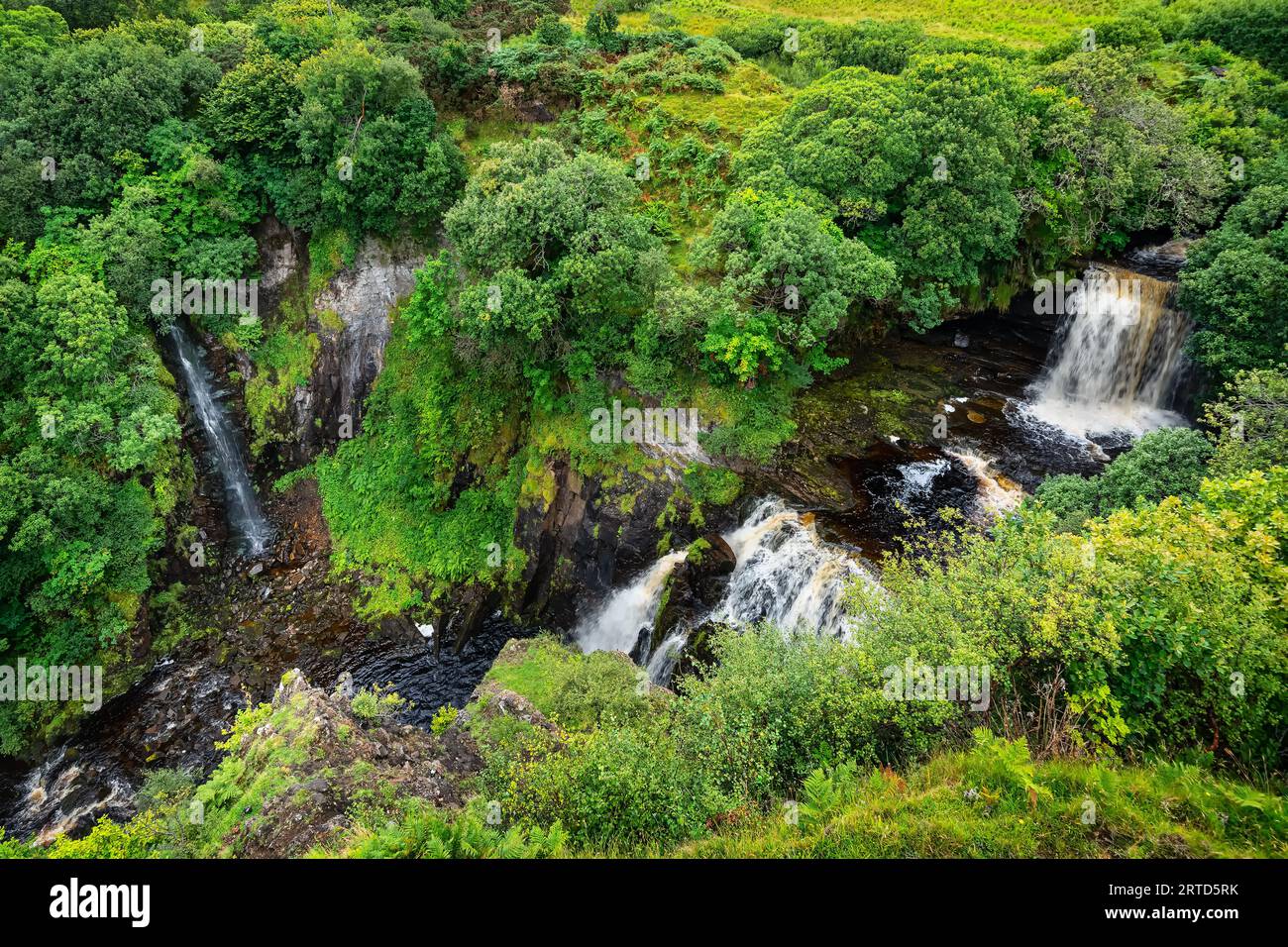 Green landscape with waterfalls coming down from the mountains on the ...
