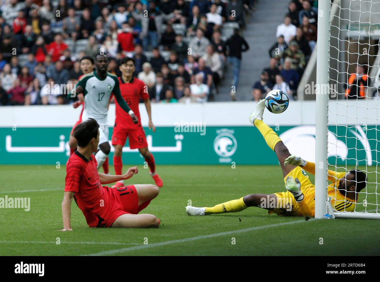 Saudi Arabia goalkeeper Mohammed Al-Owais (right) saves a shot from ...