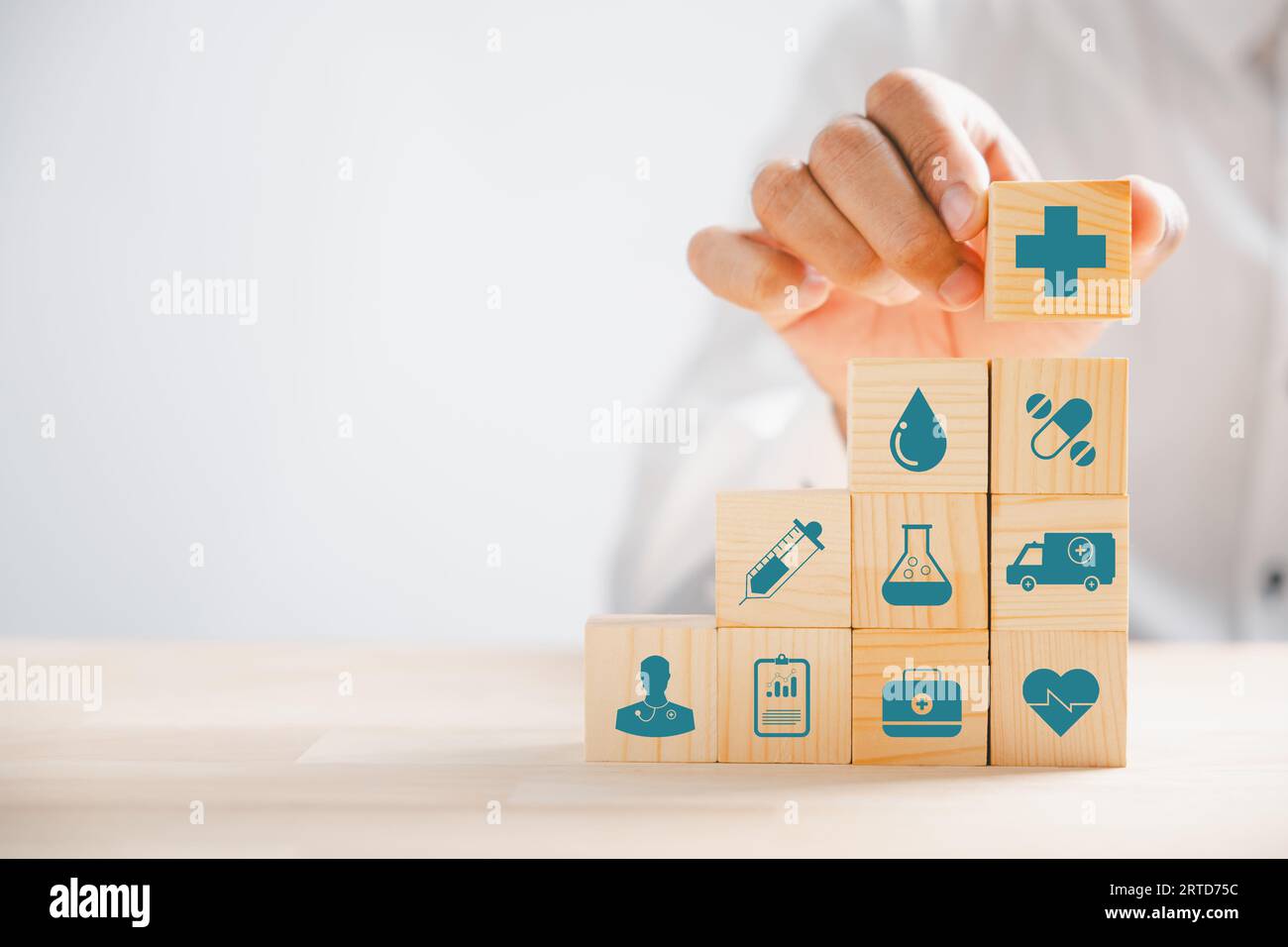 Hand hold wooden block with icon healthcare medical Stock Photo - Alamy