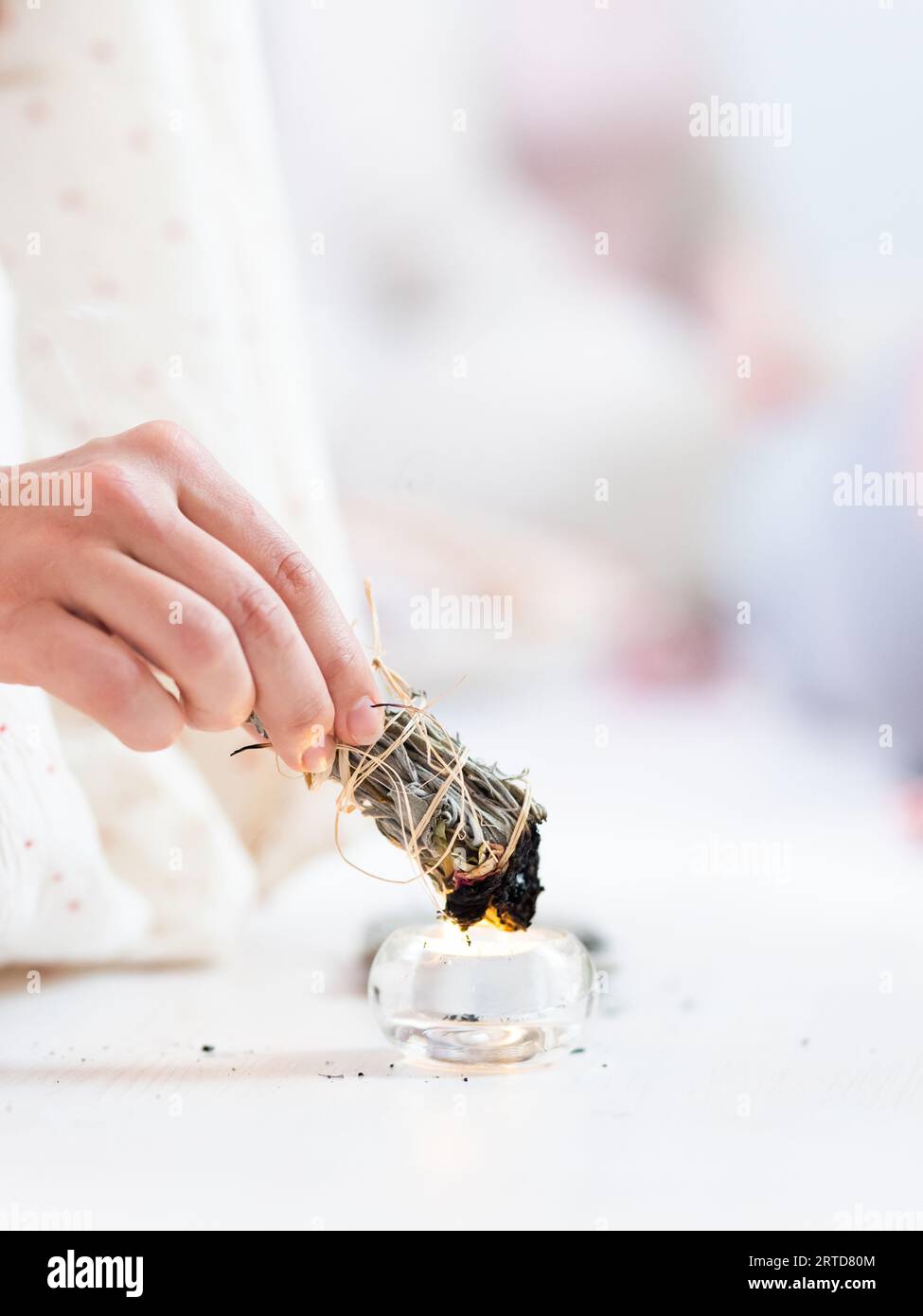 Woman lighting a smudge kit with herbal stick. Natural elements for ...