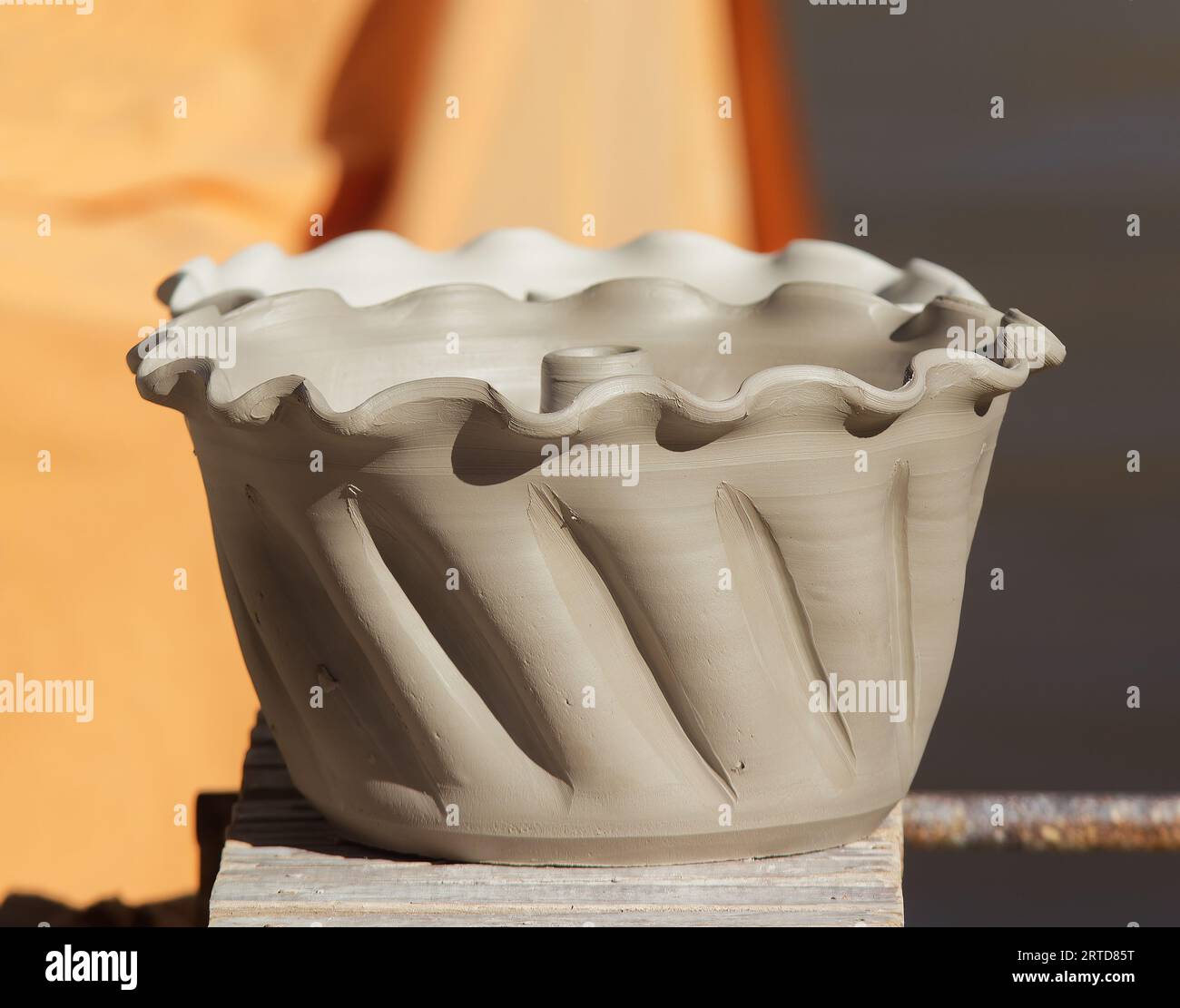 Freshly made moulds drying in the sun on display at the pottery market ...