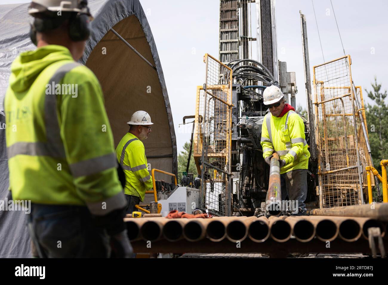 FILE - Driller Helper Chris Palmer, right, attaches a core sampling ...