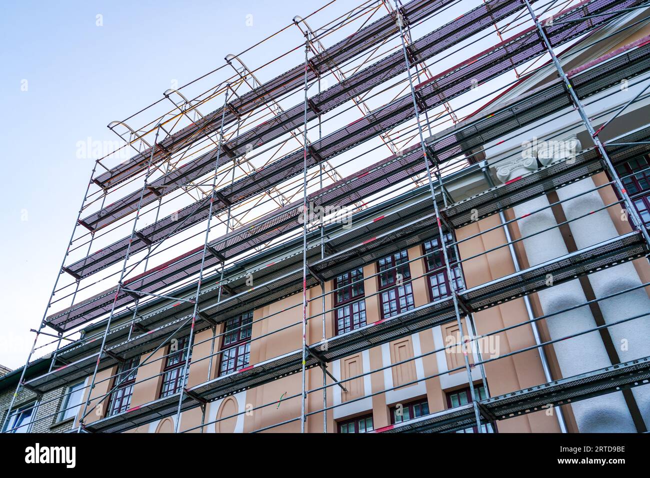 High scaffold for temporary roof being erected around a building to re ...