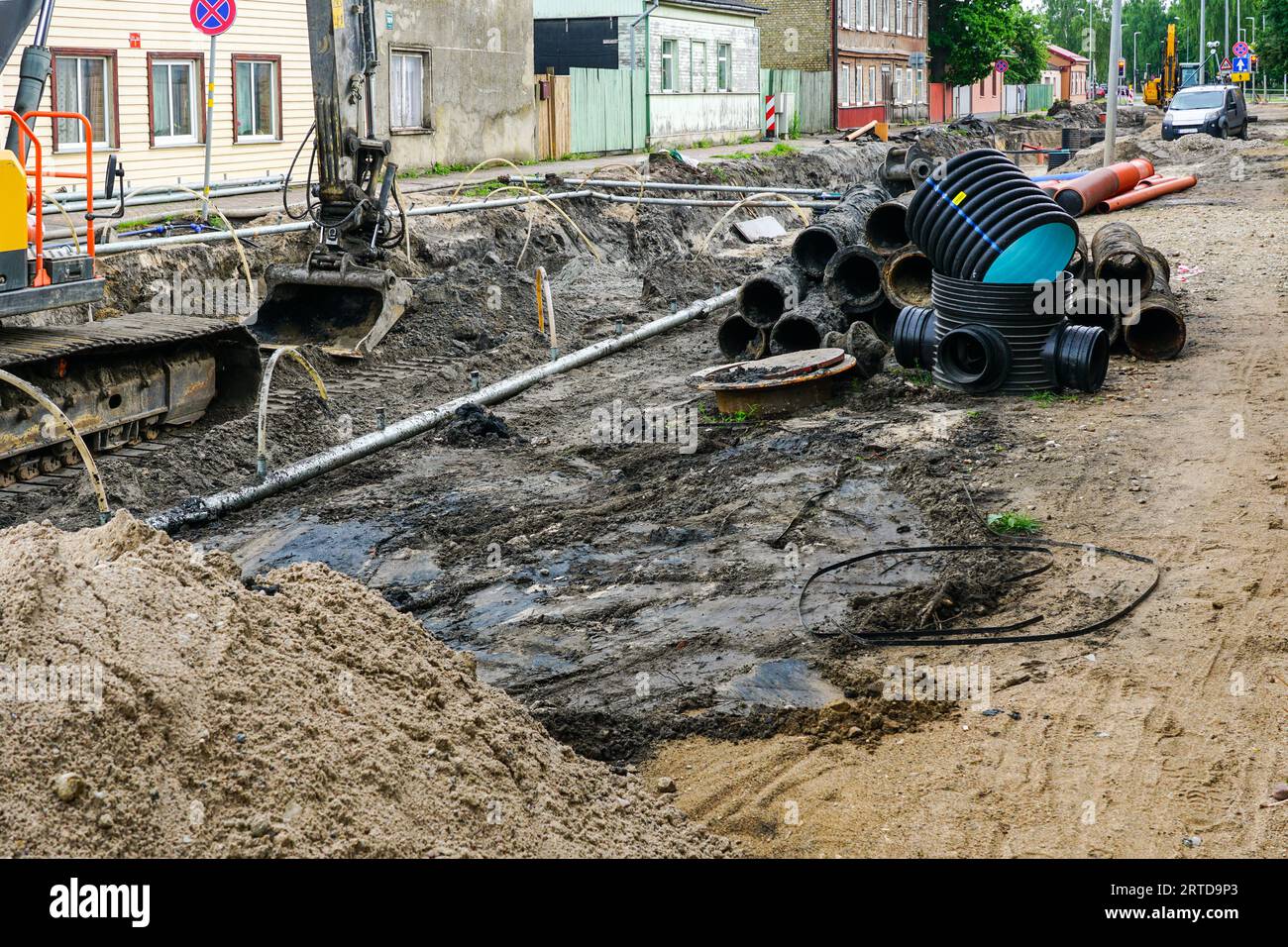Street reconstruction view, old and new underground pipes next to a ...