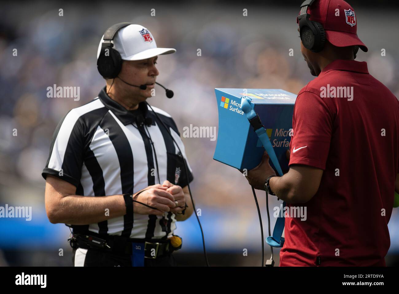 Referee Brad Allen (122) looks at Microsoft Surface tablet to review a ...