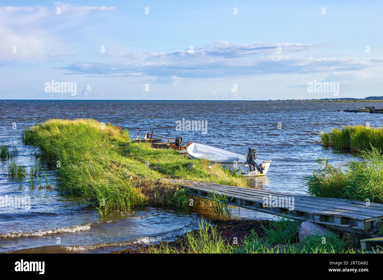 Picturesque seaside scenery of boats at the landing in the evening ...