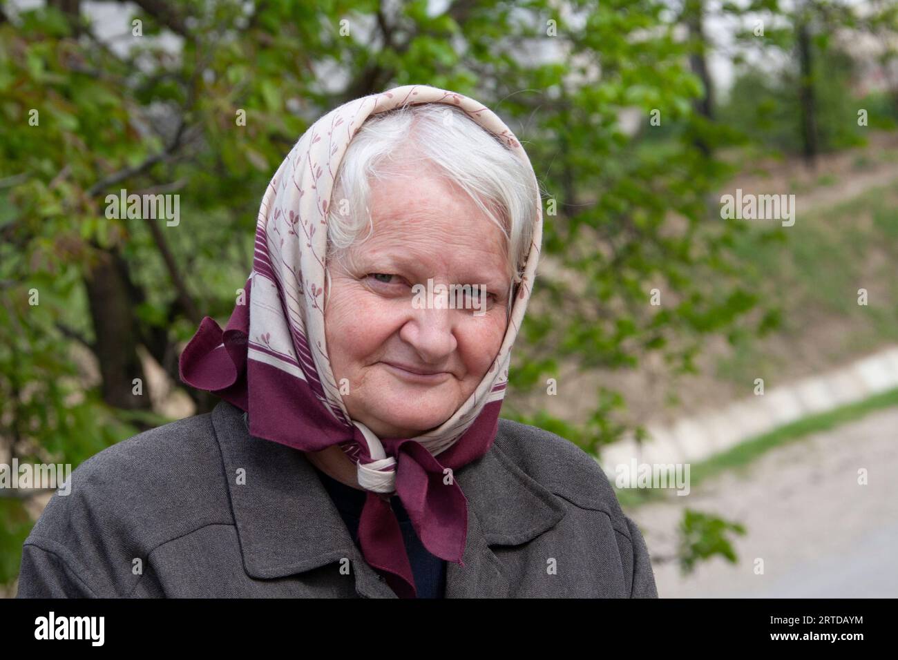 old woman with a scarf and white hair typical granny in eastern europe ...
