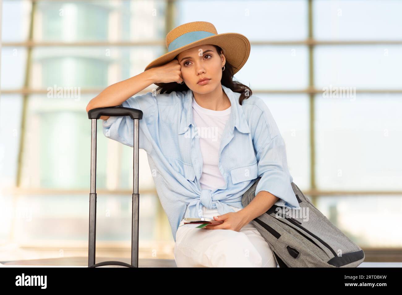 Tired sad millennial caucasian lady with suitcase and backpack has ...