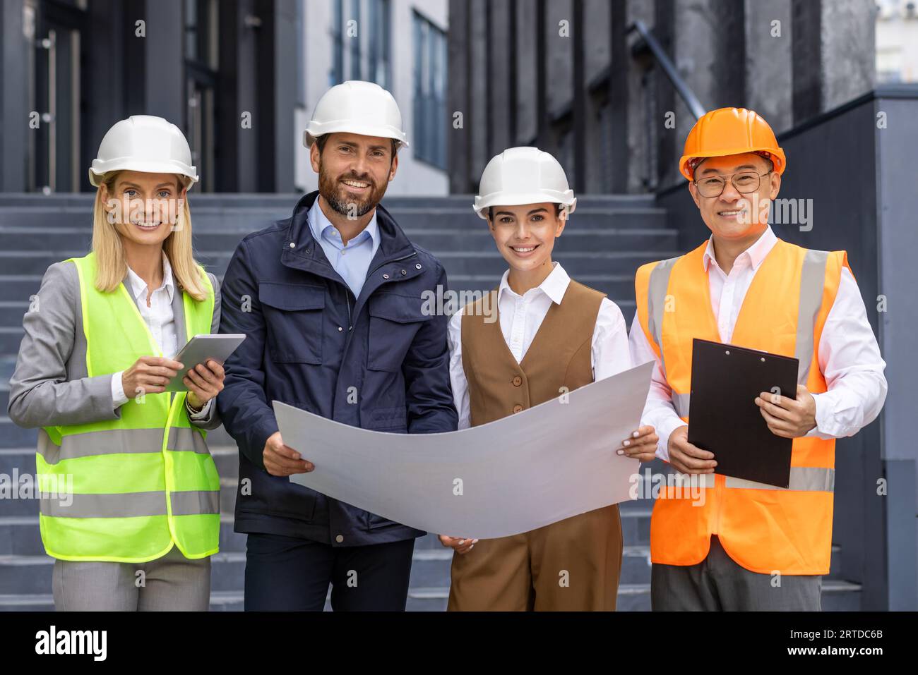 Team of architects builders, diverse group of men and women, inspecting construction stages of ...