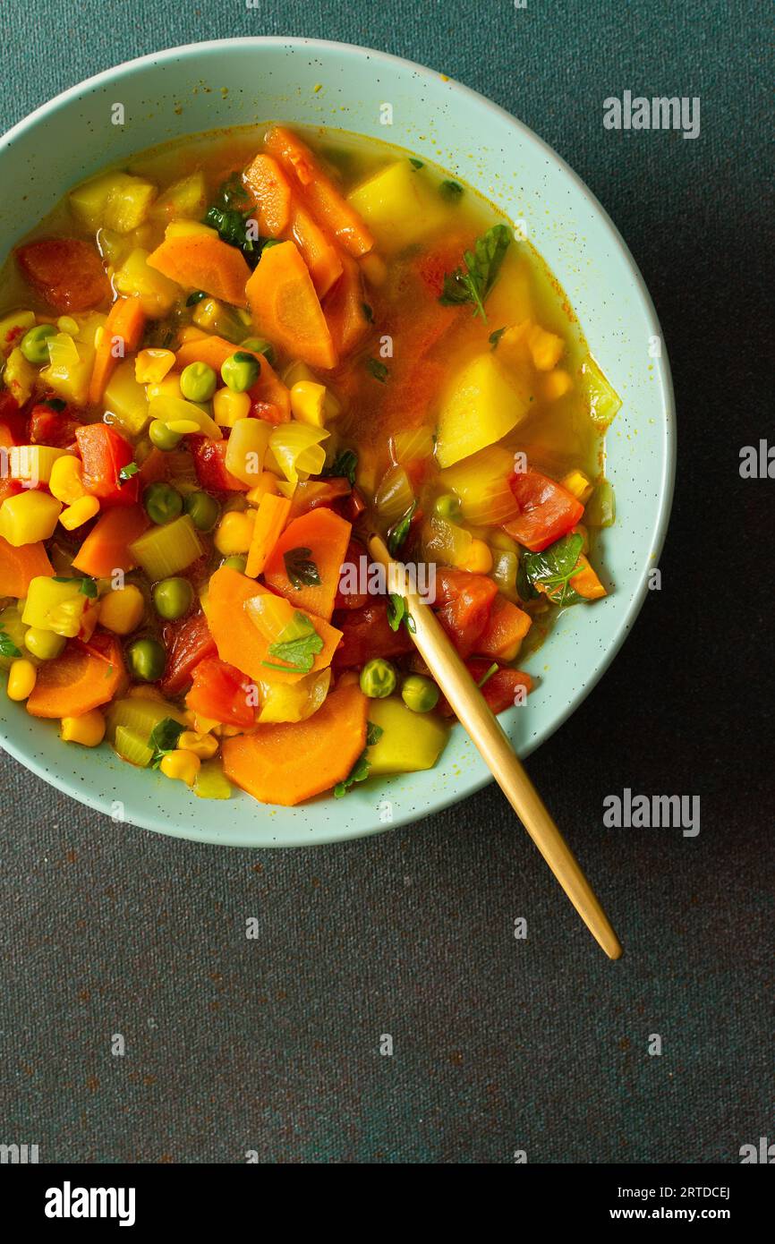 Minestrone soup from zucchini and tomato, onion and carrots, corn and ...