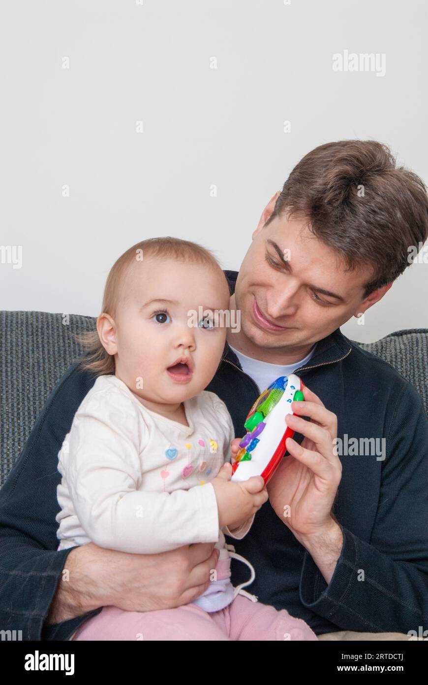 Dad playing phone with his baby daughter Stock Photo - Alamy