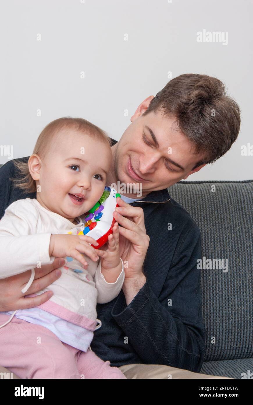 Dad playing phone with his baby daughter Stock Photo - Alamy