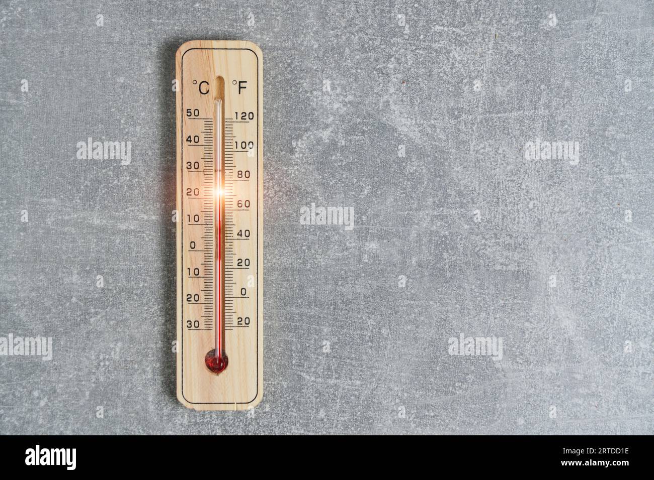 Thermometer showing high temperature.Against background concrete wall ...