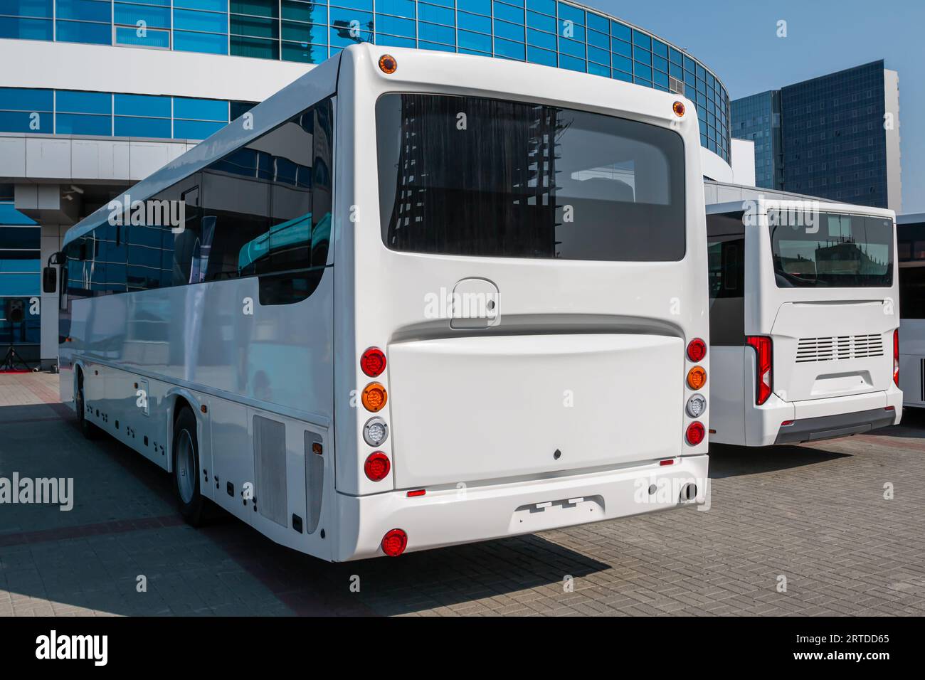 White intercity buses at the bus station on a clear day Stock Photo - Alamy