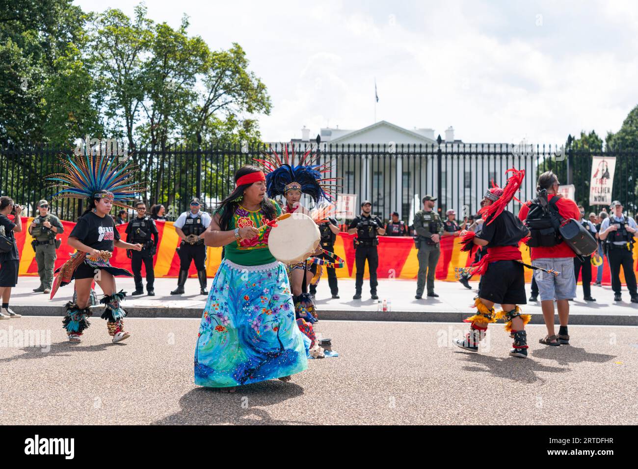 People sing and dance in front of police during a rally outside of the ...