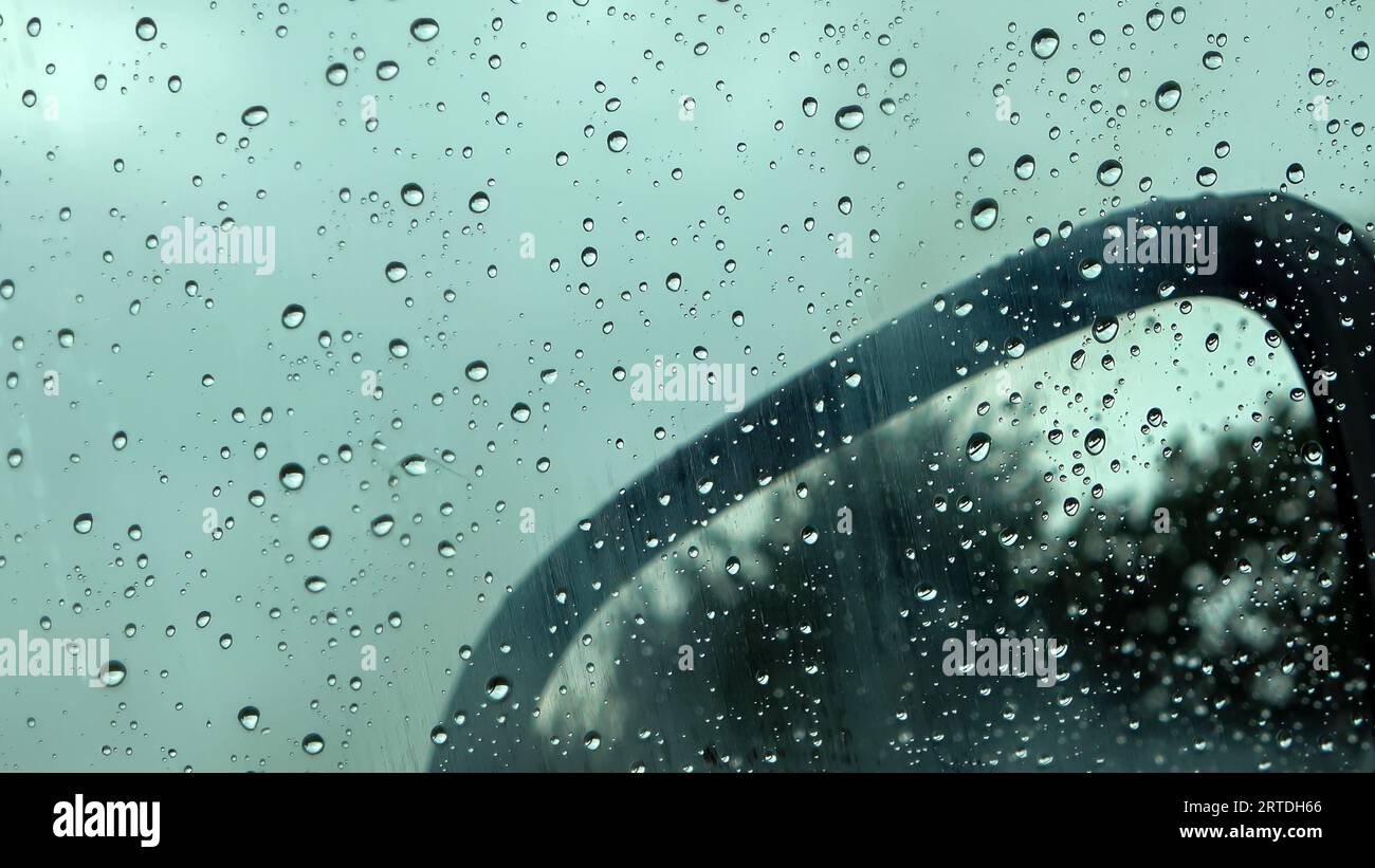 Rain Drops Running Down A Car Window In A Close Up View Stock Photo - Alamy