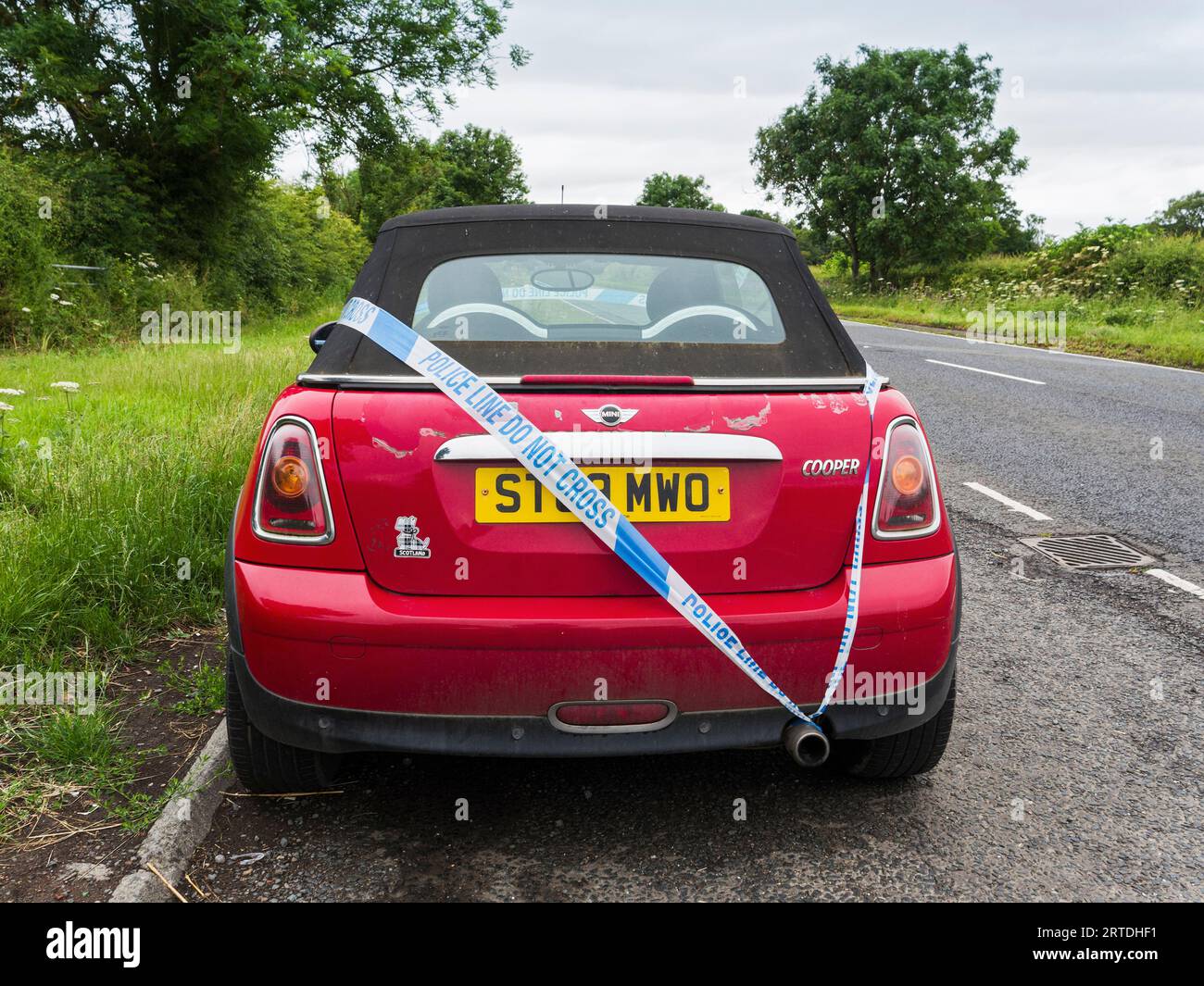 Police tape over a car giving instruction not to cross Stock Photo - Alamy