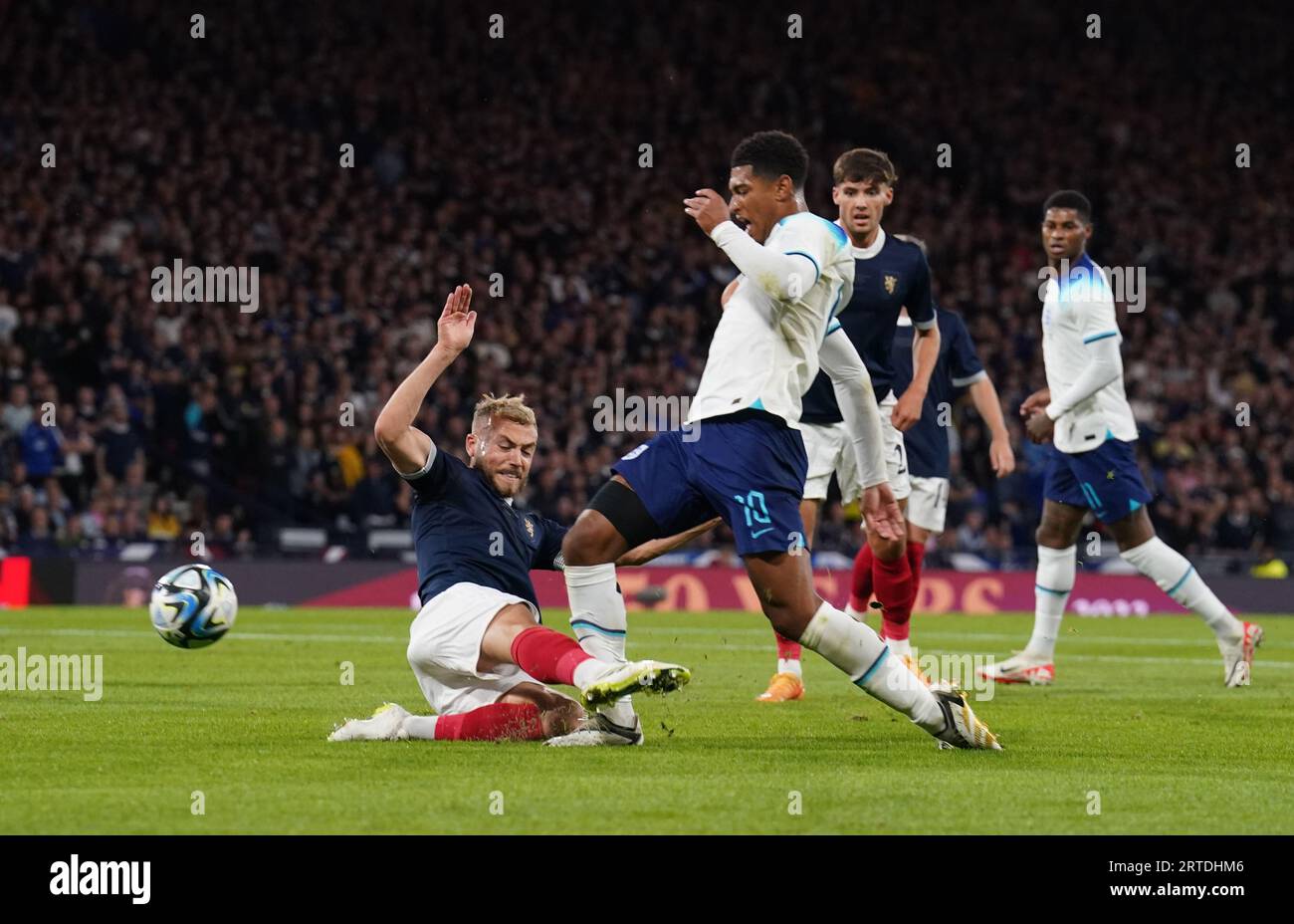 England’s Jude Bellingham is tackled by Scotland’s Ryan Porteous during ...