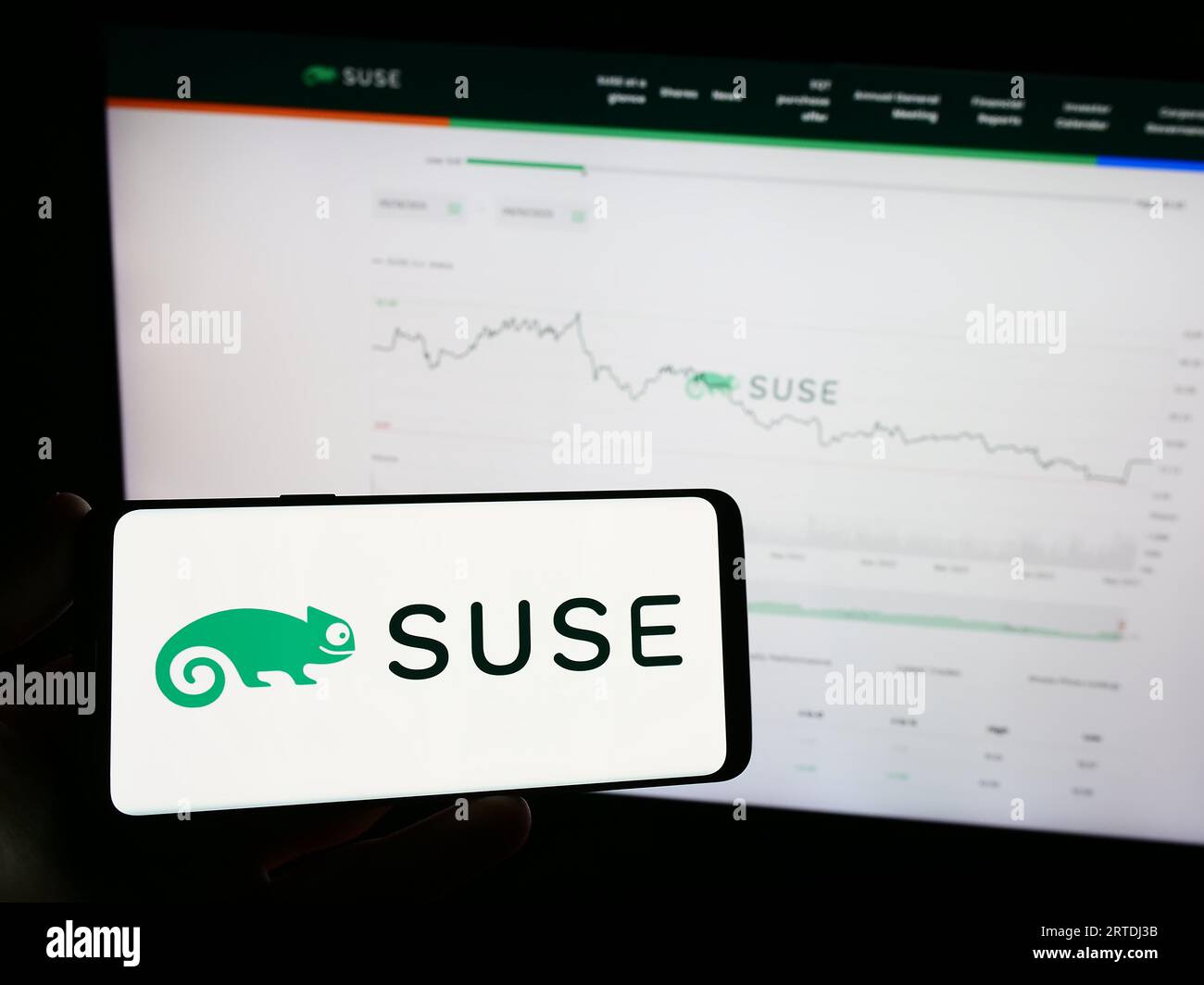 Person holding mobile phone with logo of open-source software company ...