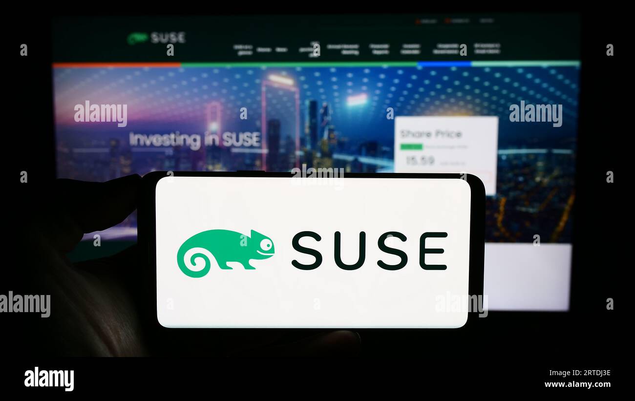 Person holding smartphone with logo of open-source software company ...