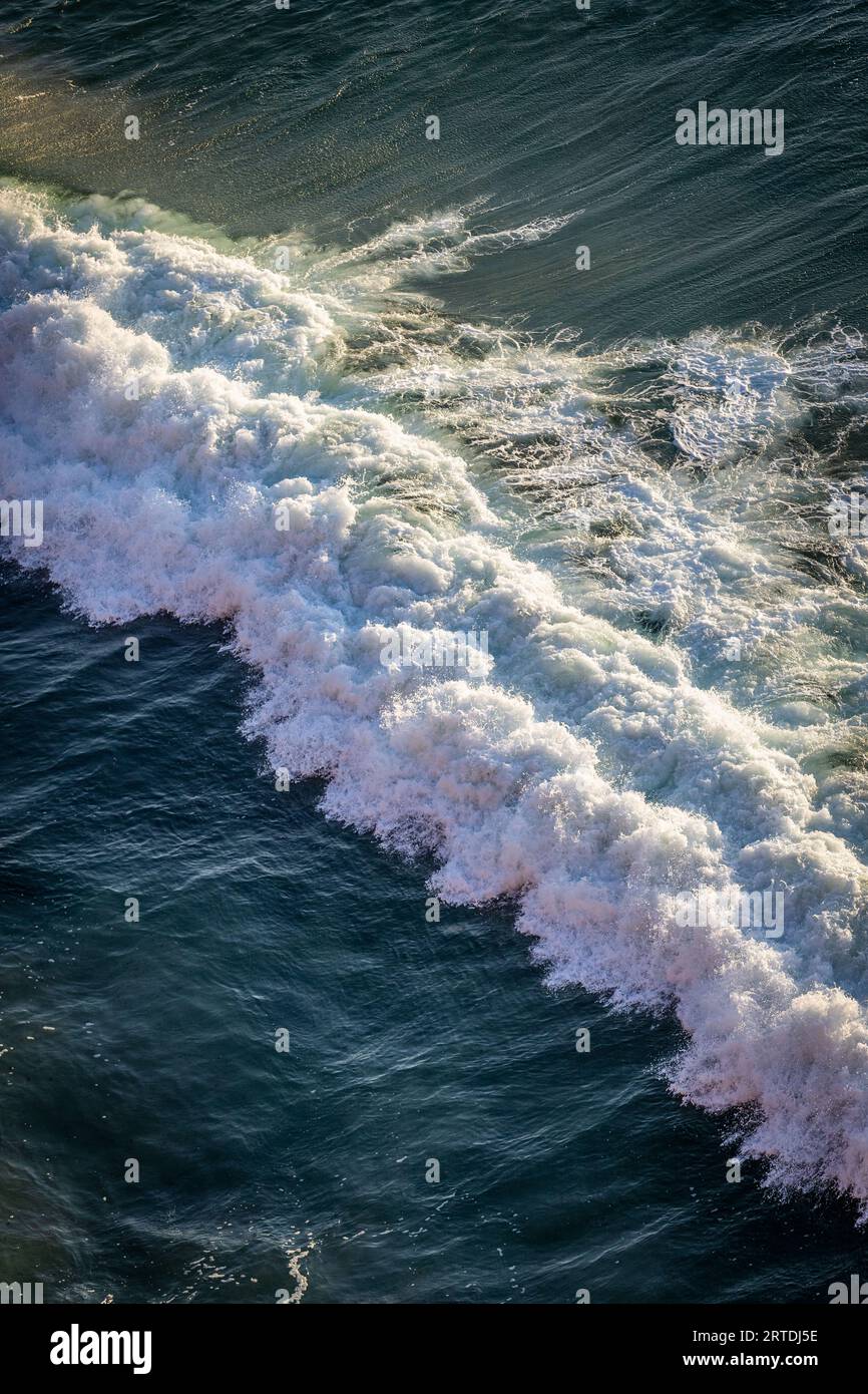A view of the rolling ocean wave reflecting the warm sunlight Stock ...