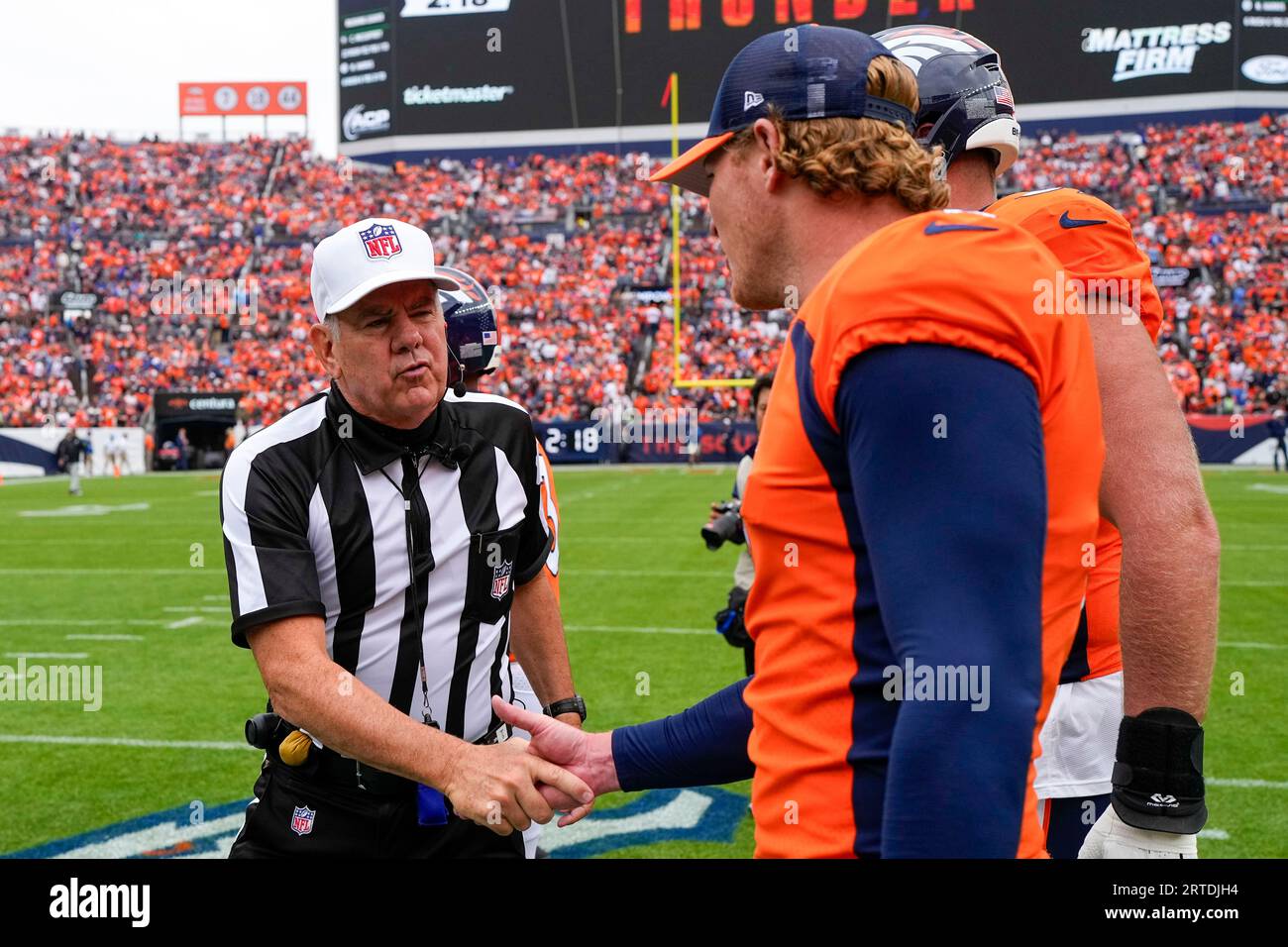 Referee Bill Vinovich (52) shakes hands with Denver Broncos punter ...
