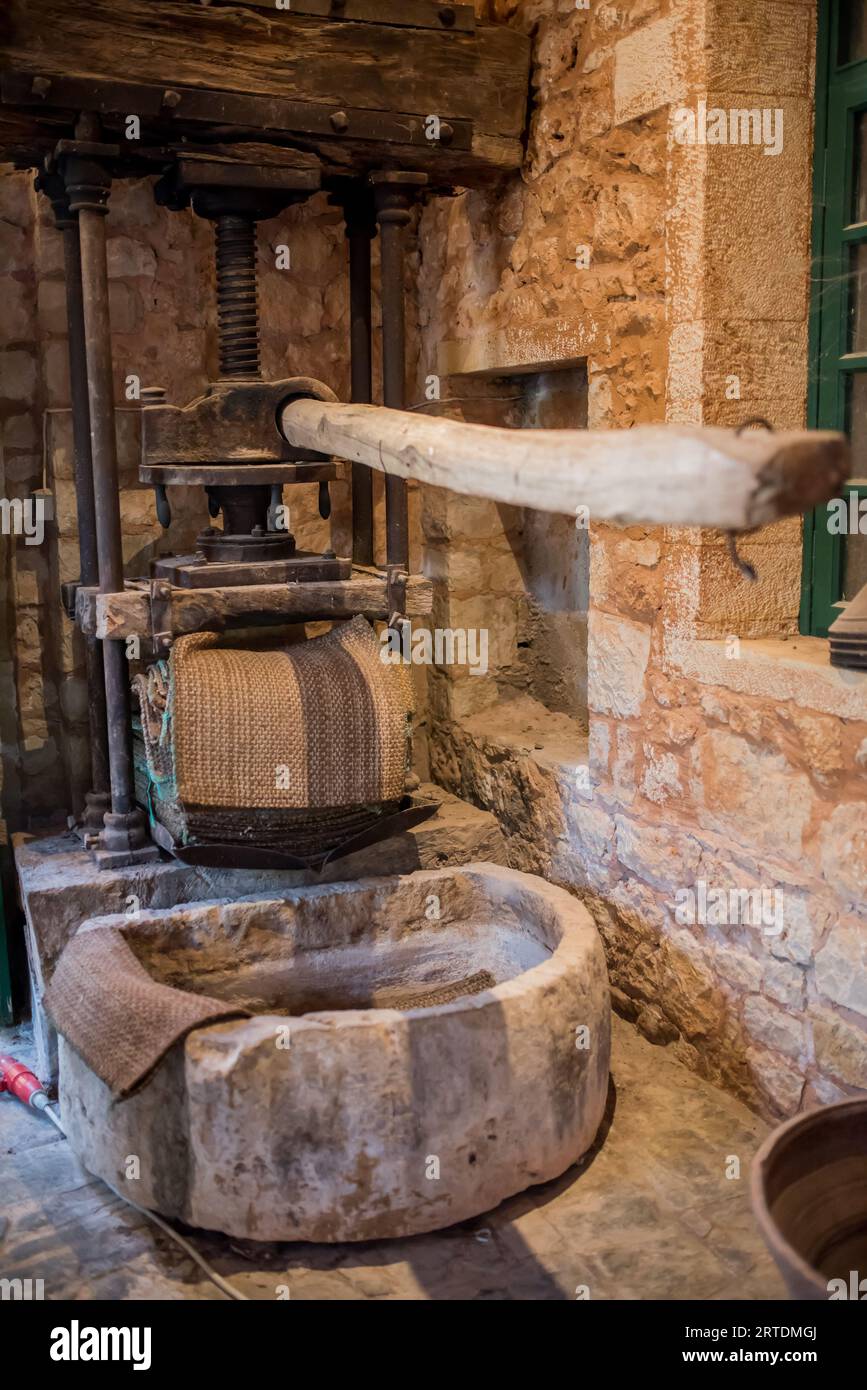 An antique wooden machine for squeeze olives to produce fresh olive oil ...